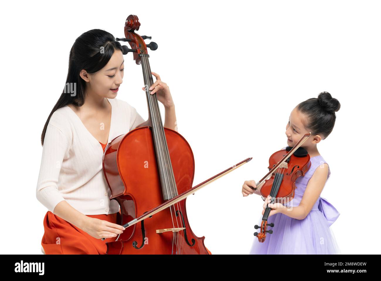 The female teacher guide girl playing Musical Instruments Stock Photo ...