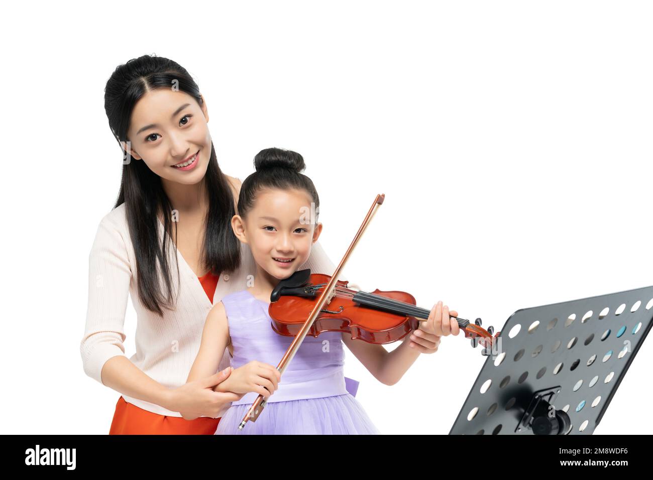 The female teacher guide girl playing Musical Instruments Stock Photo ...