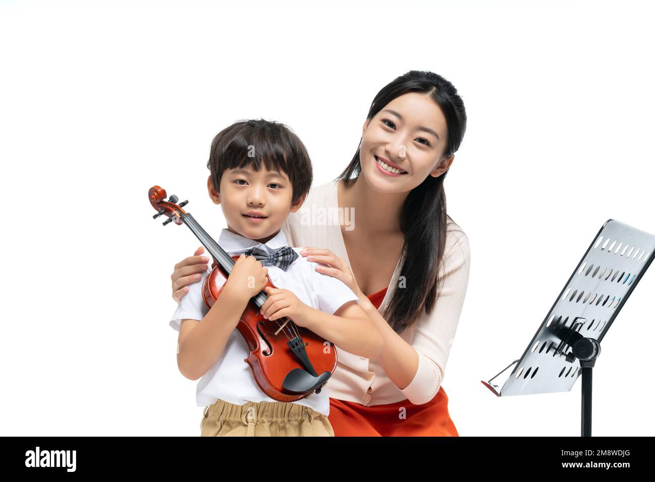 The female teacher guide the boy playing Musical Instruments Stock ...