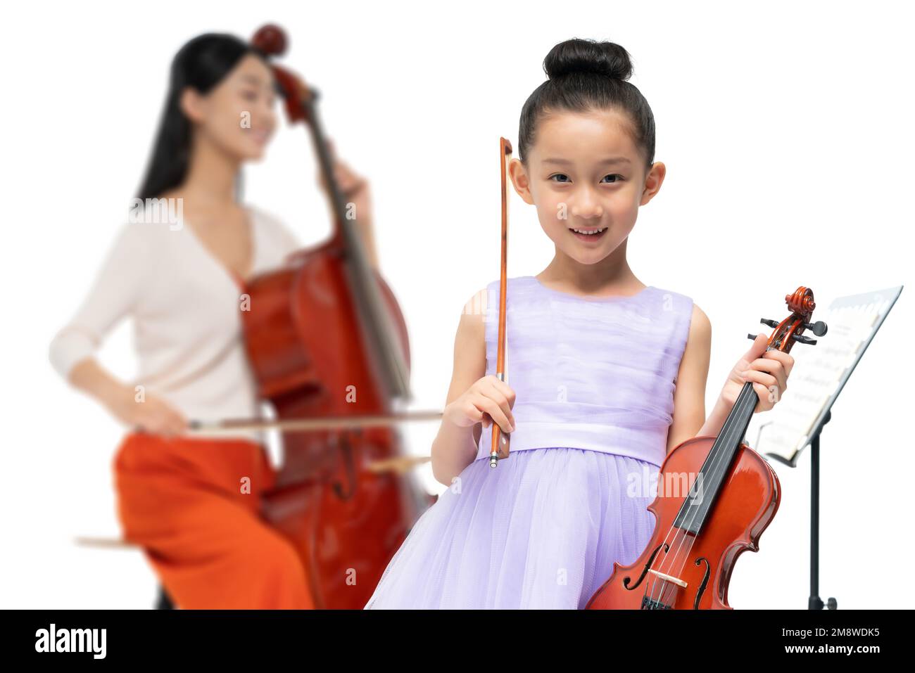 The female teacher guide girl playing Musical Instruments Stock Photo ...