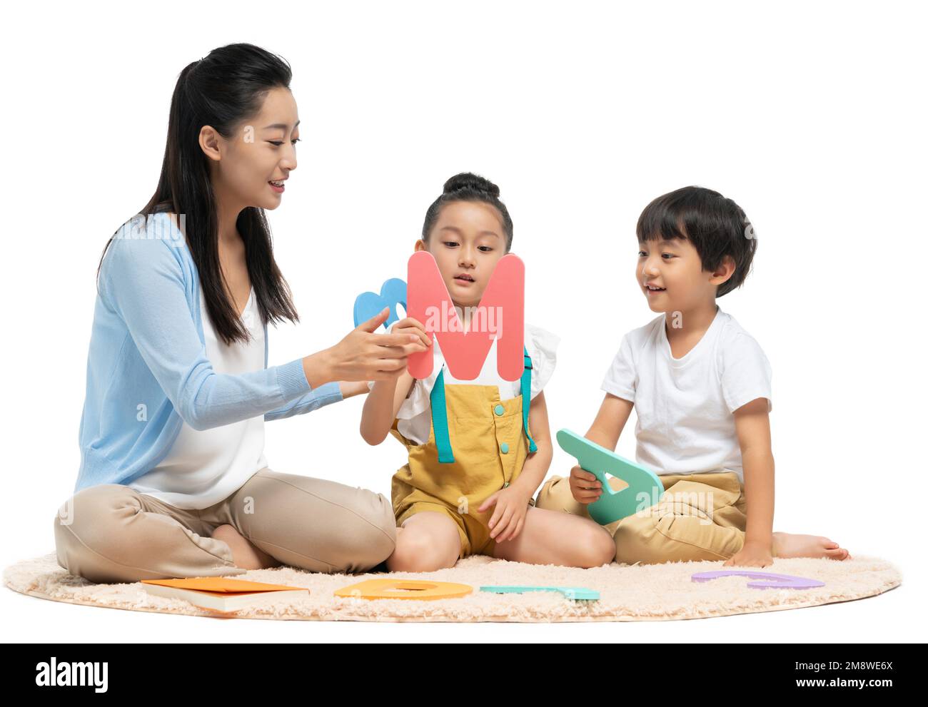 A young female teacher counseling students learning Stock Photo - Alamy