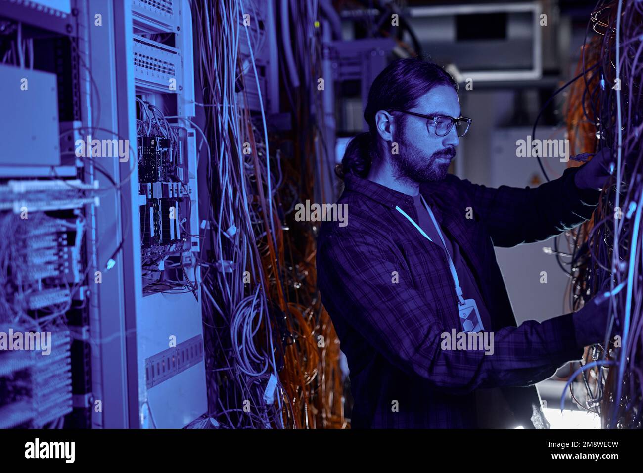 Side view portrait of bearded man as system administrator working with ...