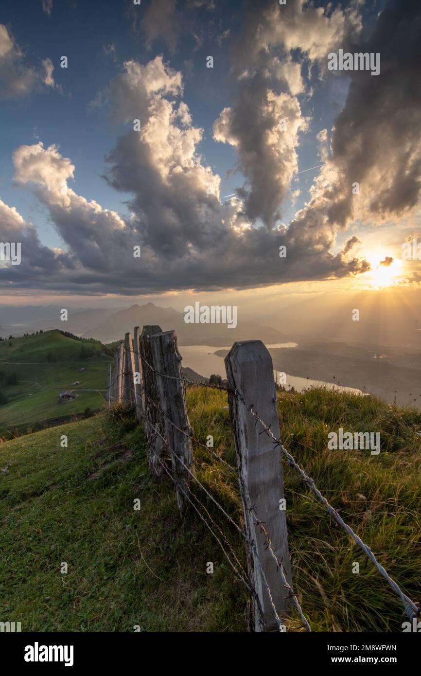 Sunset on a mountain with an old fence Stock Photo - Alamy