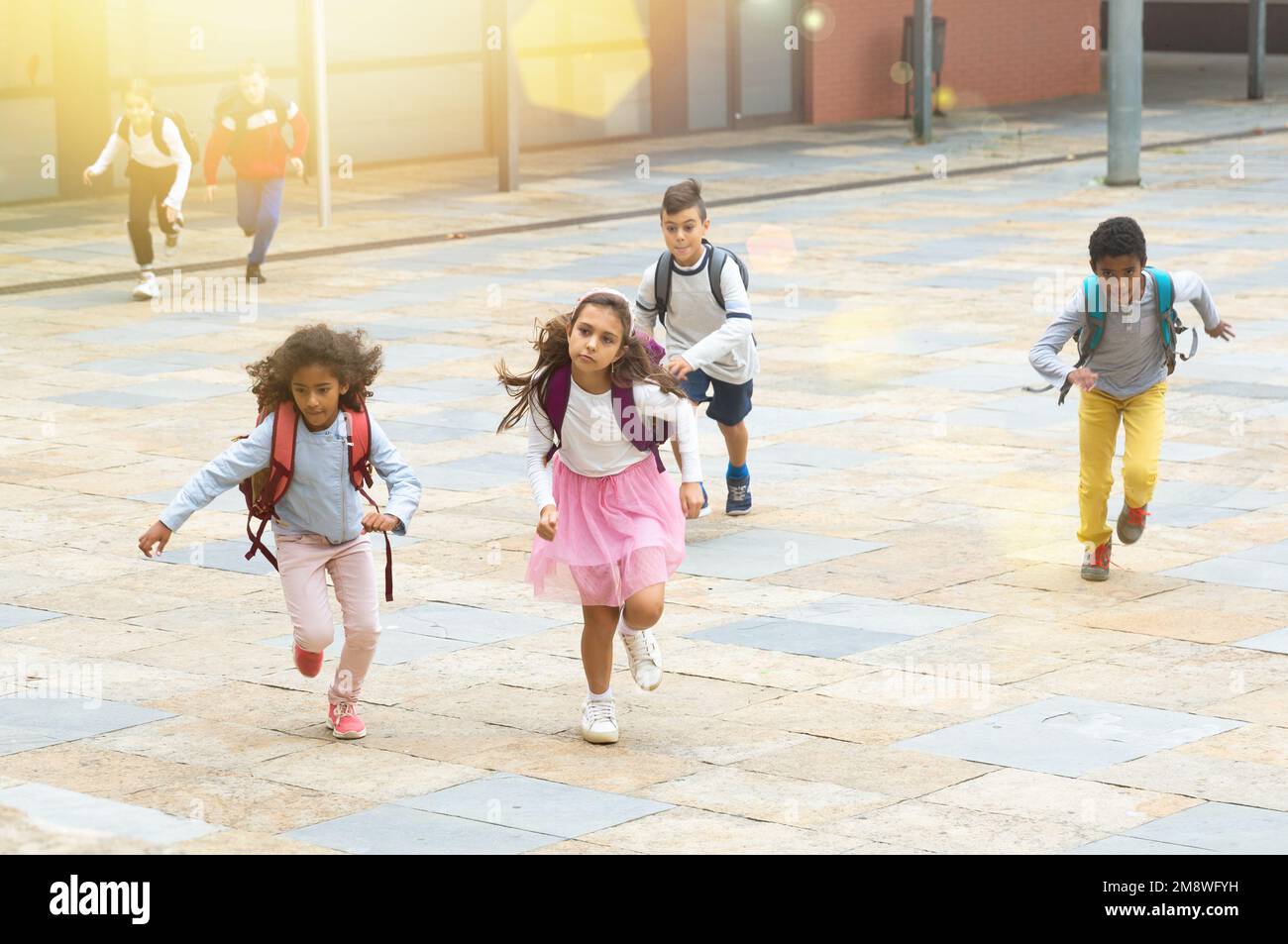 Happy schoolchildren running in the race from school outdoors Stock ...