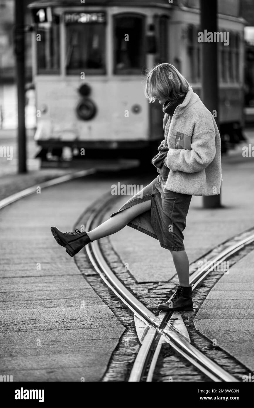 A woman near the old city streetcar. Black and white photo Stock Photo ...