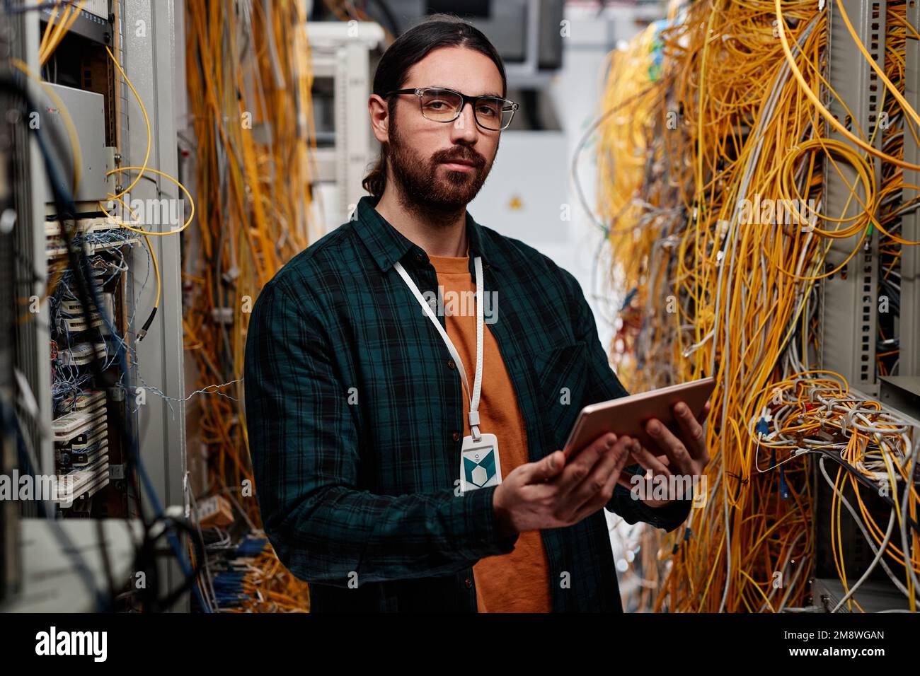 Waist up portrait of bearded man as system administrator standing in ...