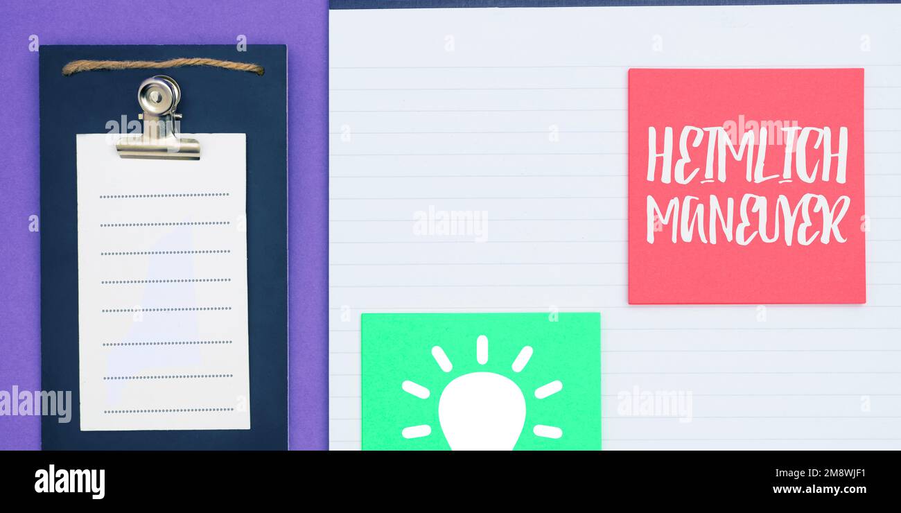 Hand writing sign Heimlich Maneuver. Word for application of upward ...