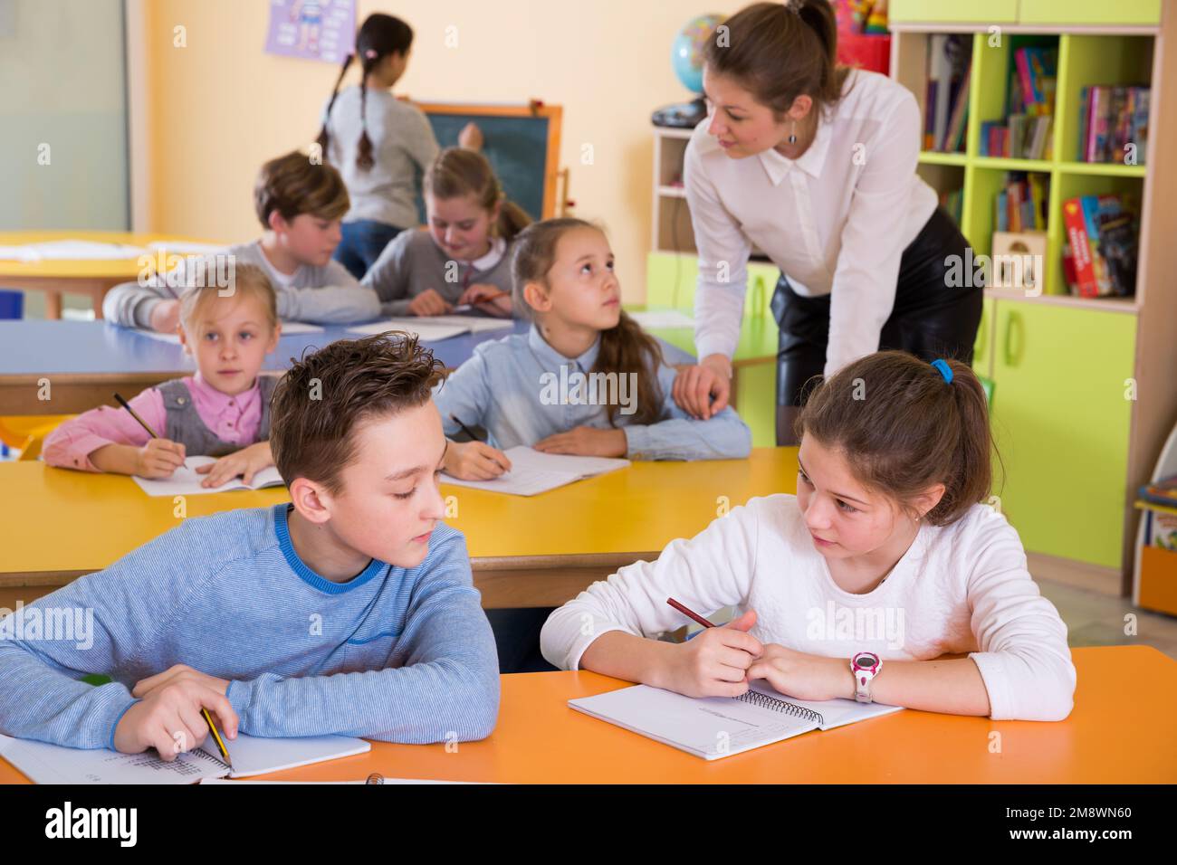 School kids studying in classroom with teacher Stock Photo - Alamy