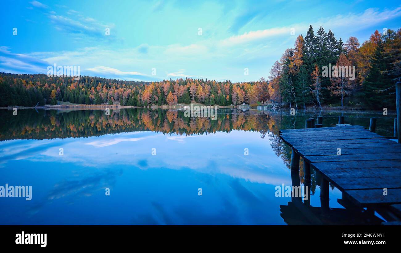A beautiful scenery of fall trees around Felixer lake with reflection ...