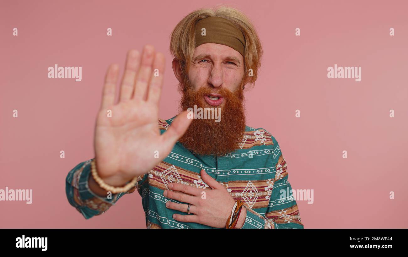 No stop. Serious hippie man say No, hold palm folded crossed hands in ...