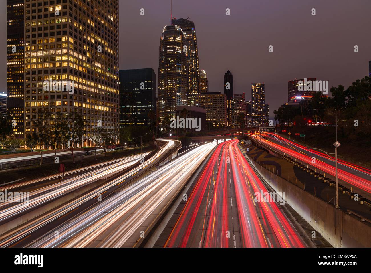 Los Angeles financial district skyline with rush hour traffic streaming ...