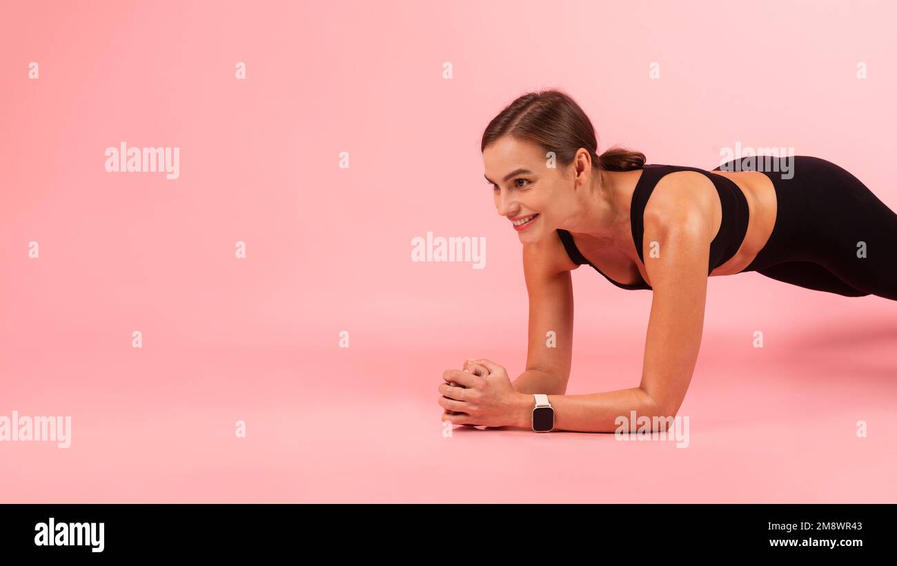 Beautiful Sporty Young Woman Doing Plank Exercise While Training In ...