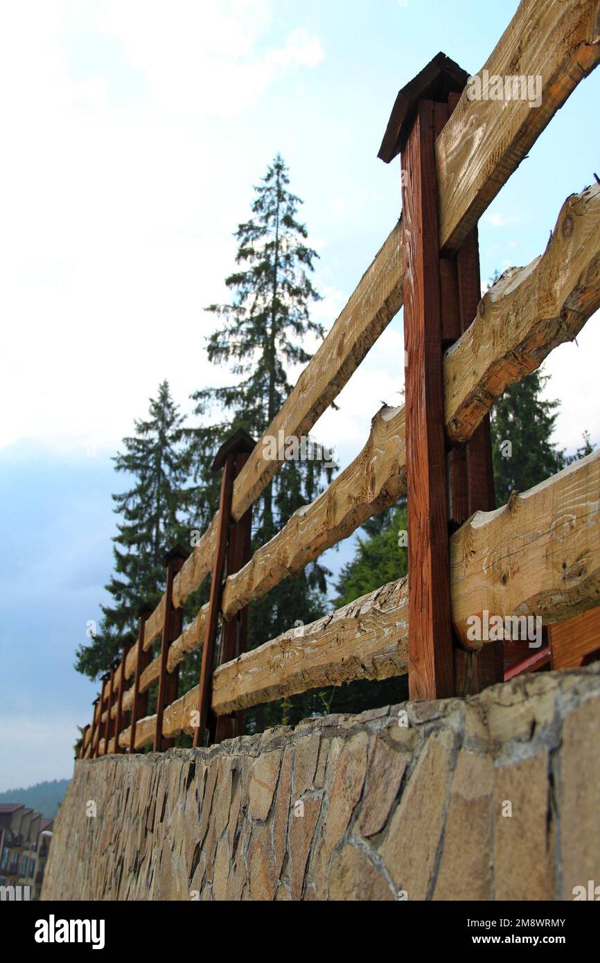 Pine Trees Behind Wood Barrier In Mountain Village Stock Photo - Alamy