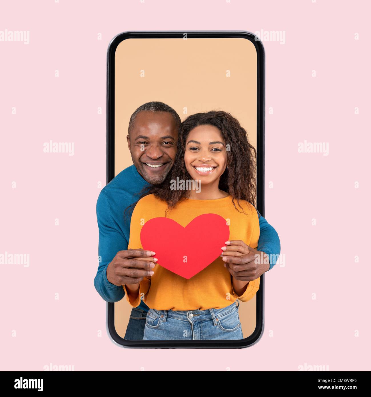 Love and care. Happy black spouses hugging holding red paper card heart ...
