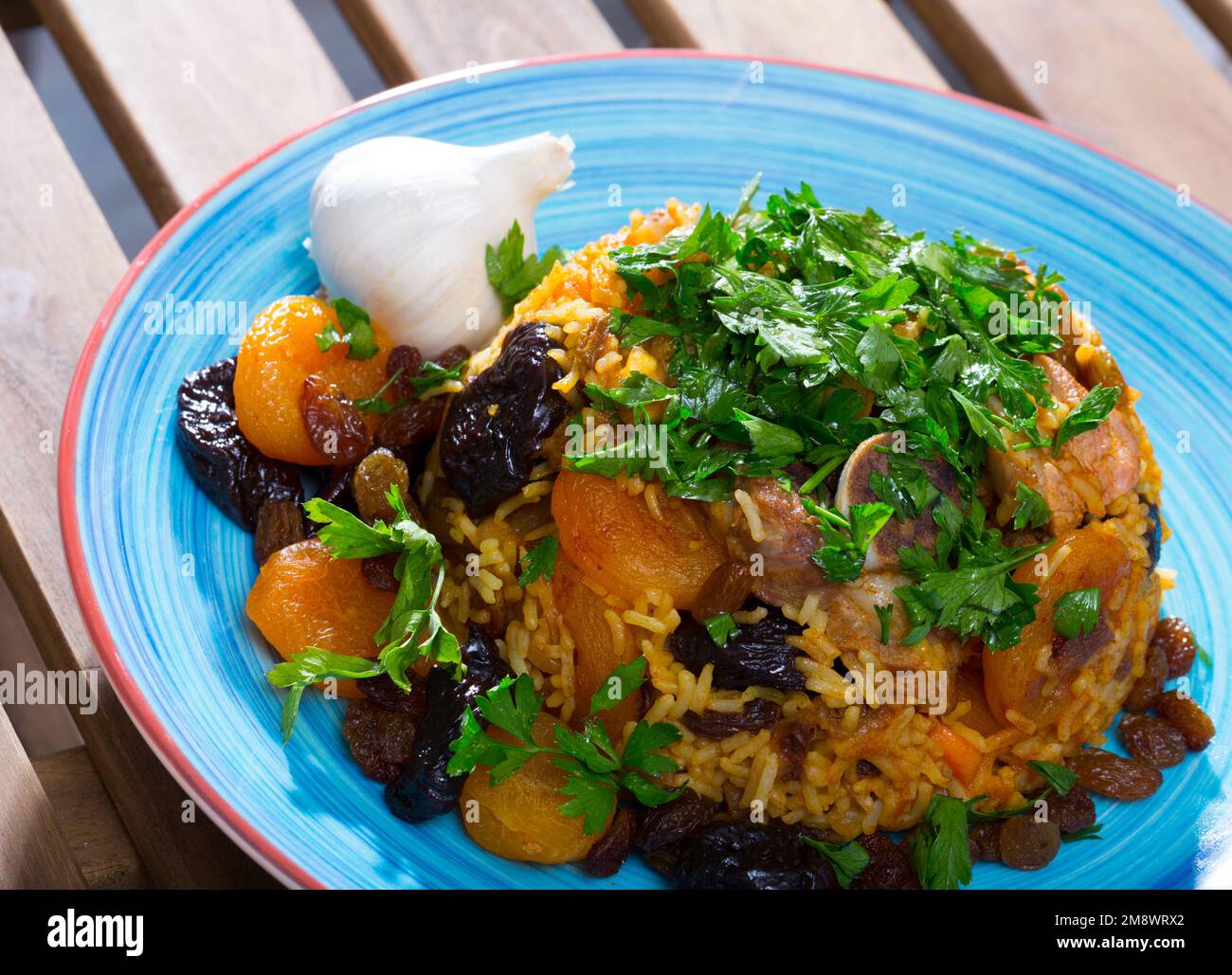 Pilaw with mutton, dried fruits and garlic Stock Photo - Alamy
