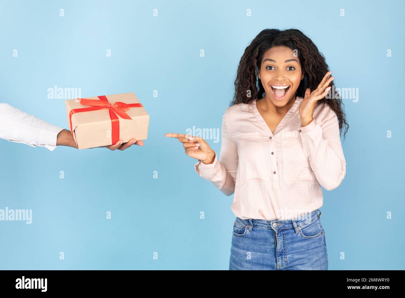 Holiday celebration concept. Male hand holding gift and giving box to ...