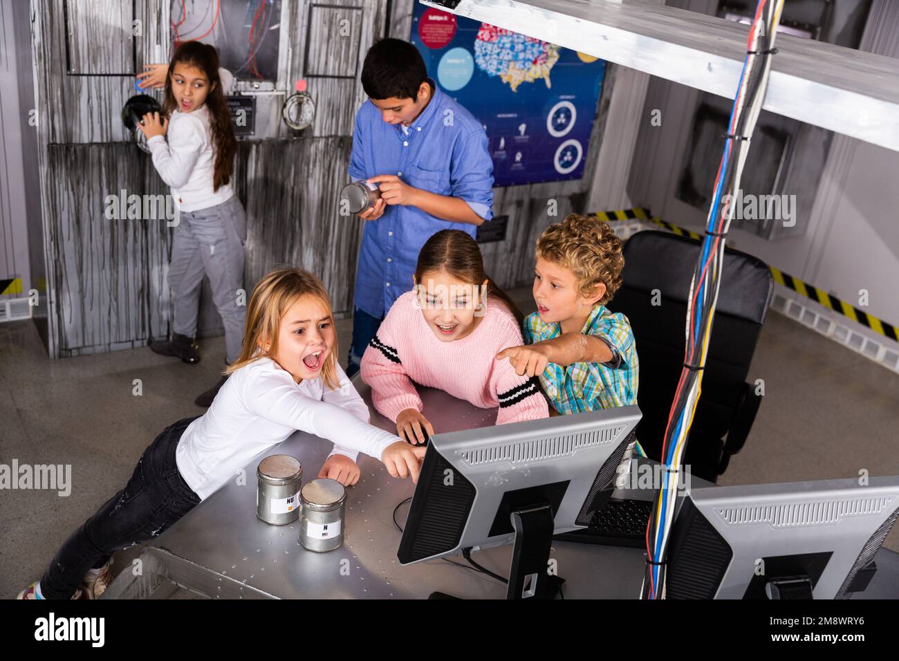 Emotional tween children using computer in quest room shelter Stock ...