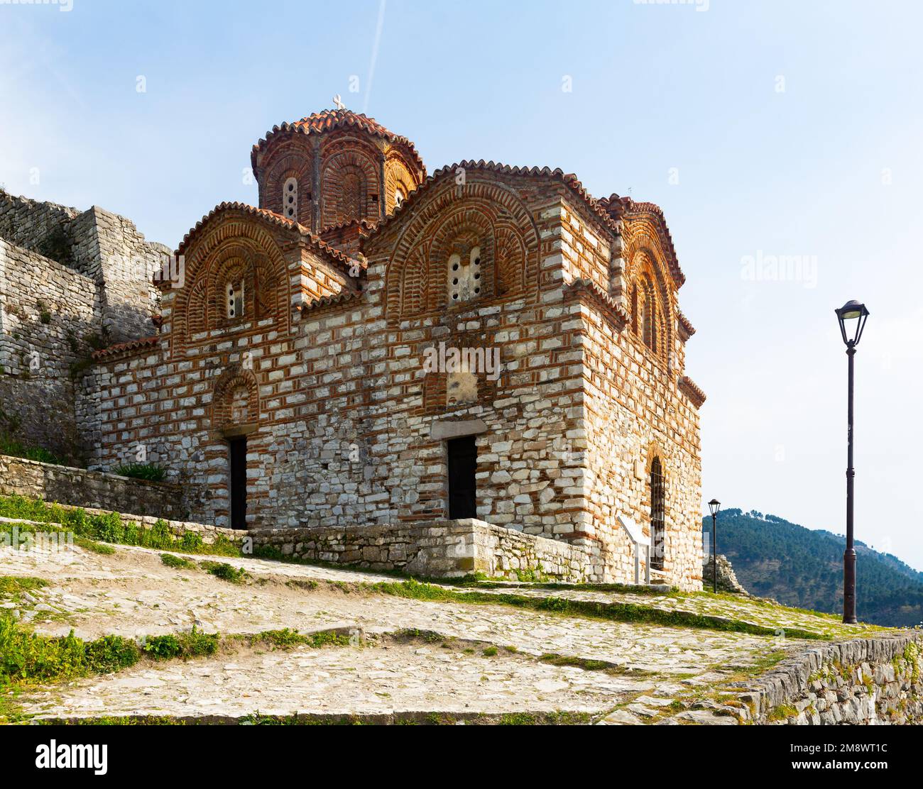 Medieval Holy Trinity Church on green flowering hill in Berat Stock ...