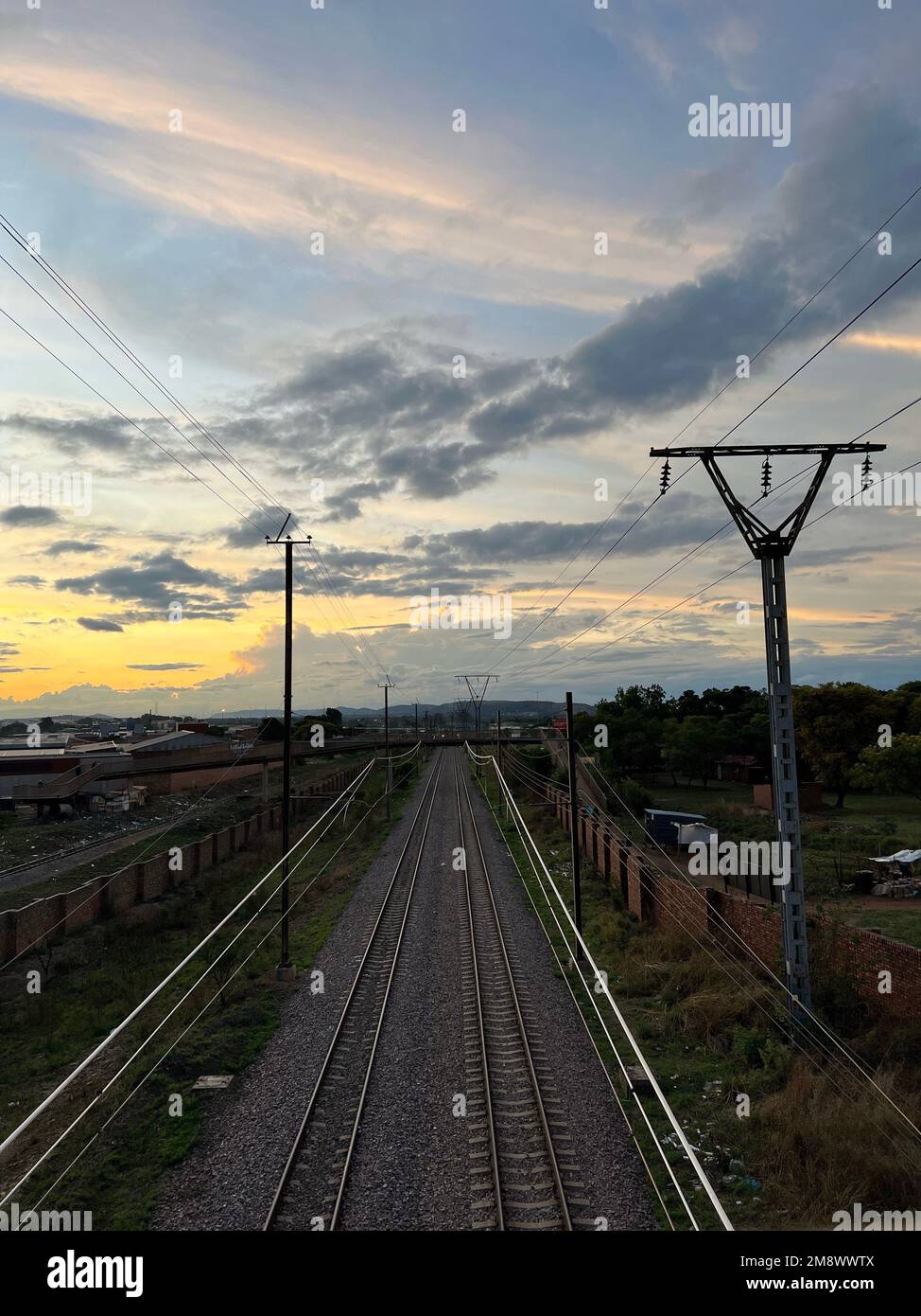 A vertical aerial view of train racks and overhead power supply with a ...