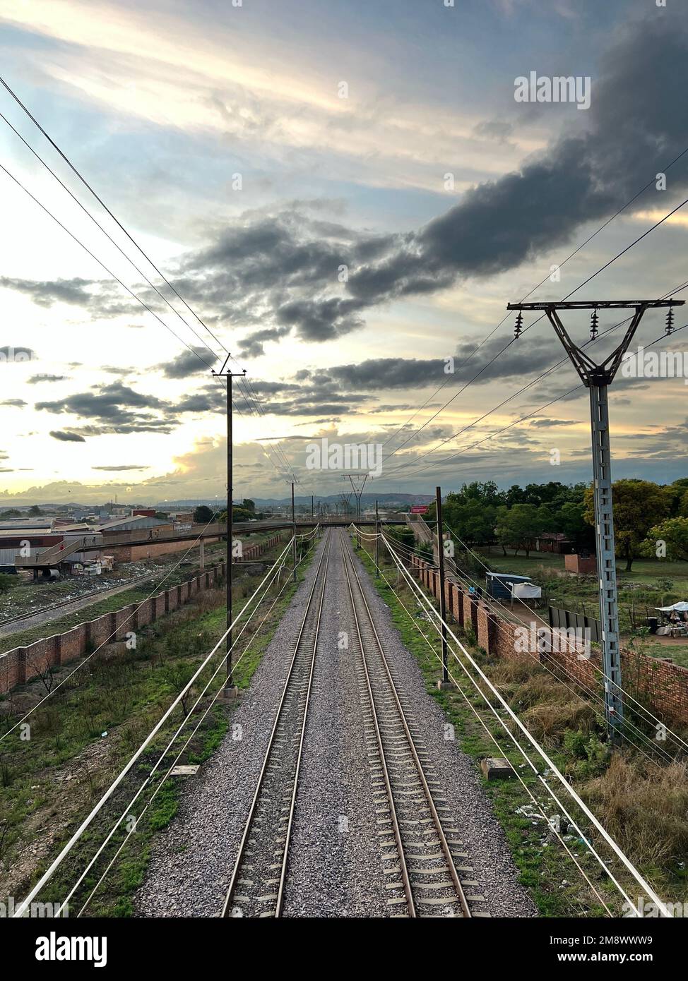 A vertical aerial view of train racks and overhead power supply lines ...
