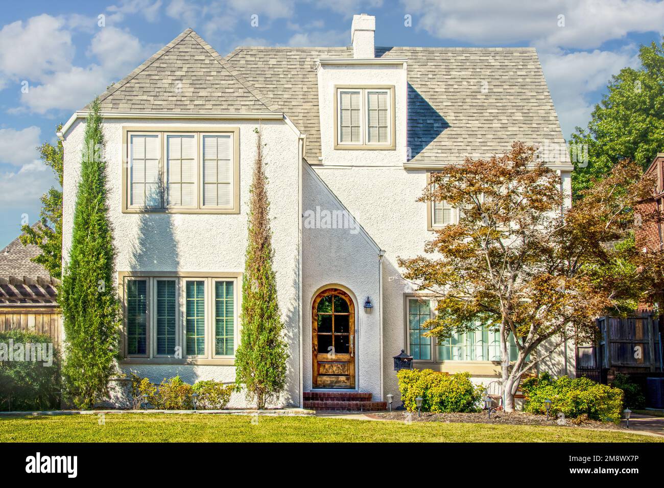 Stately Three story light colored stucco house with arched door and ...