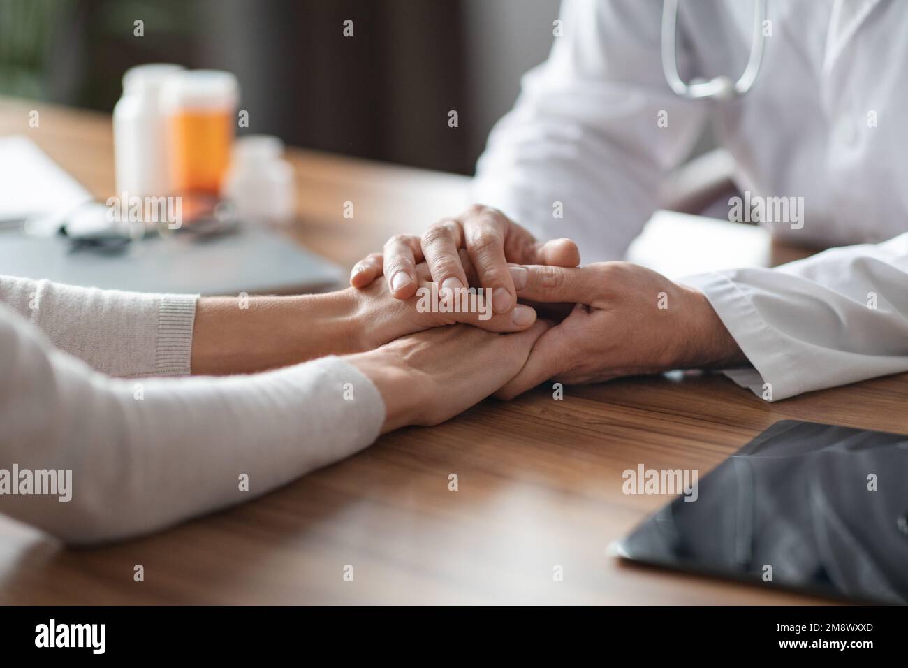 Closeup Shot Of Doctor Man Comforting Female Patient After Sharing Bad ...