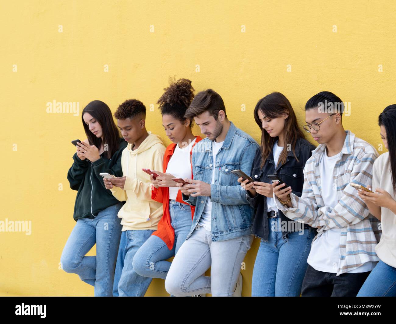 Group of diverse students chat and watch digital content on mobile ...