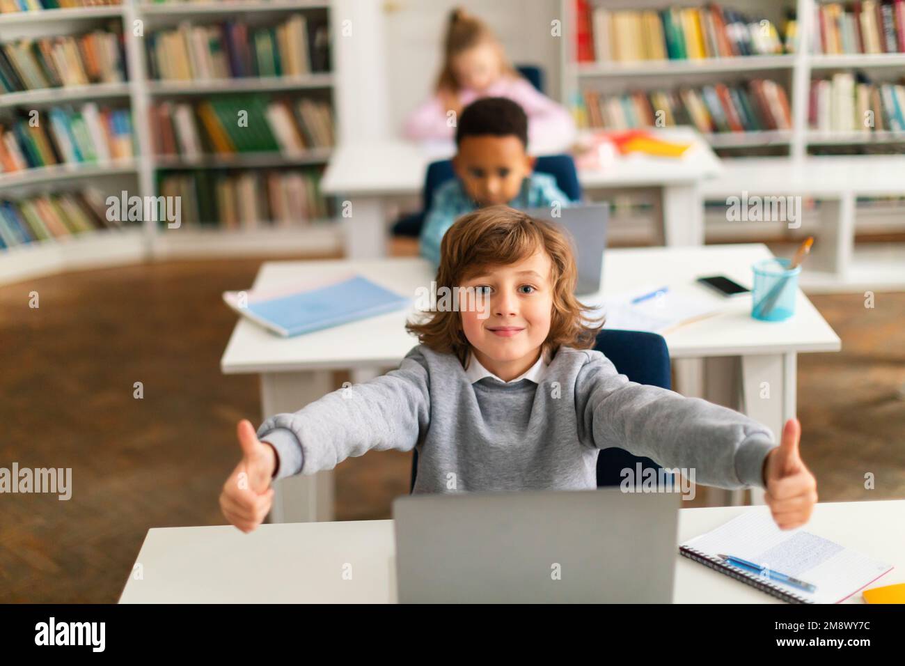 Education concept. Group of diverse classmates sitting at desk in ...
