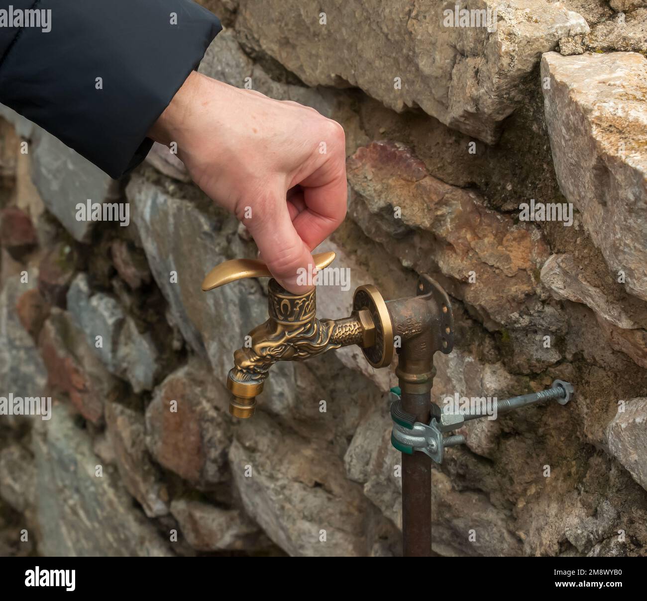 Antique brass water faucet as an architectural monument. Old tap with ...