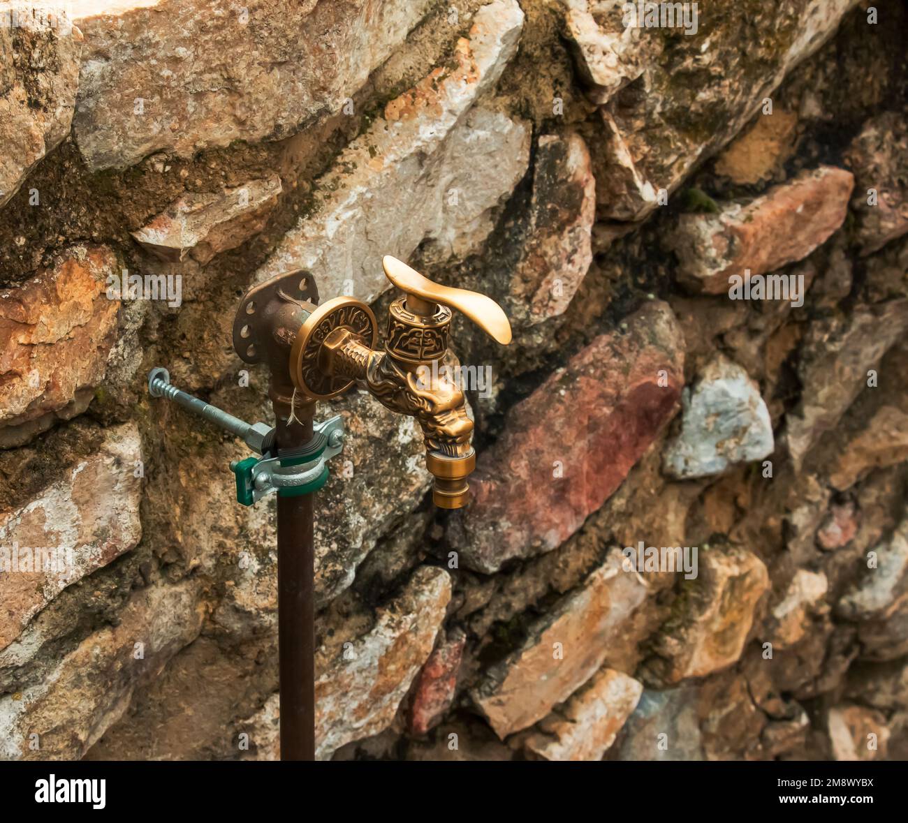 Antique brass water faucet as an architectural monument. Old tap with ...