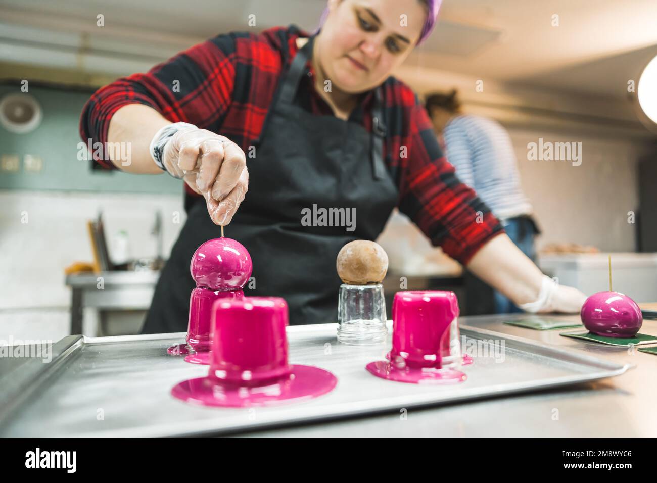 Female baker glazing dessert hi-res stock photography and images - Alamy