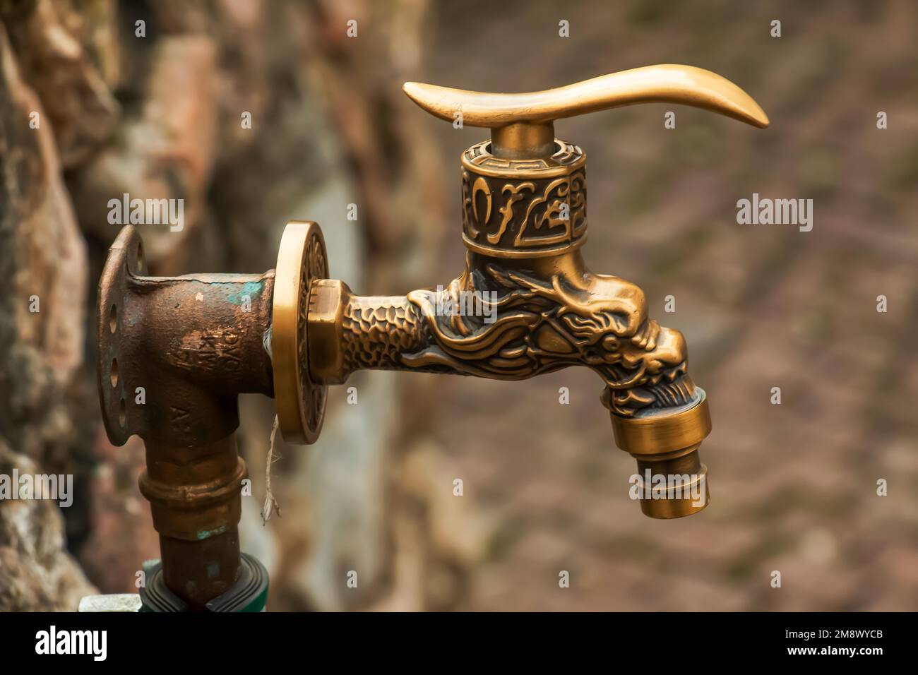 Antique brass water faucet as an architectural monument. Old tap with ...