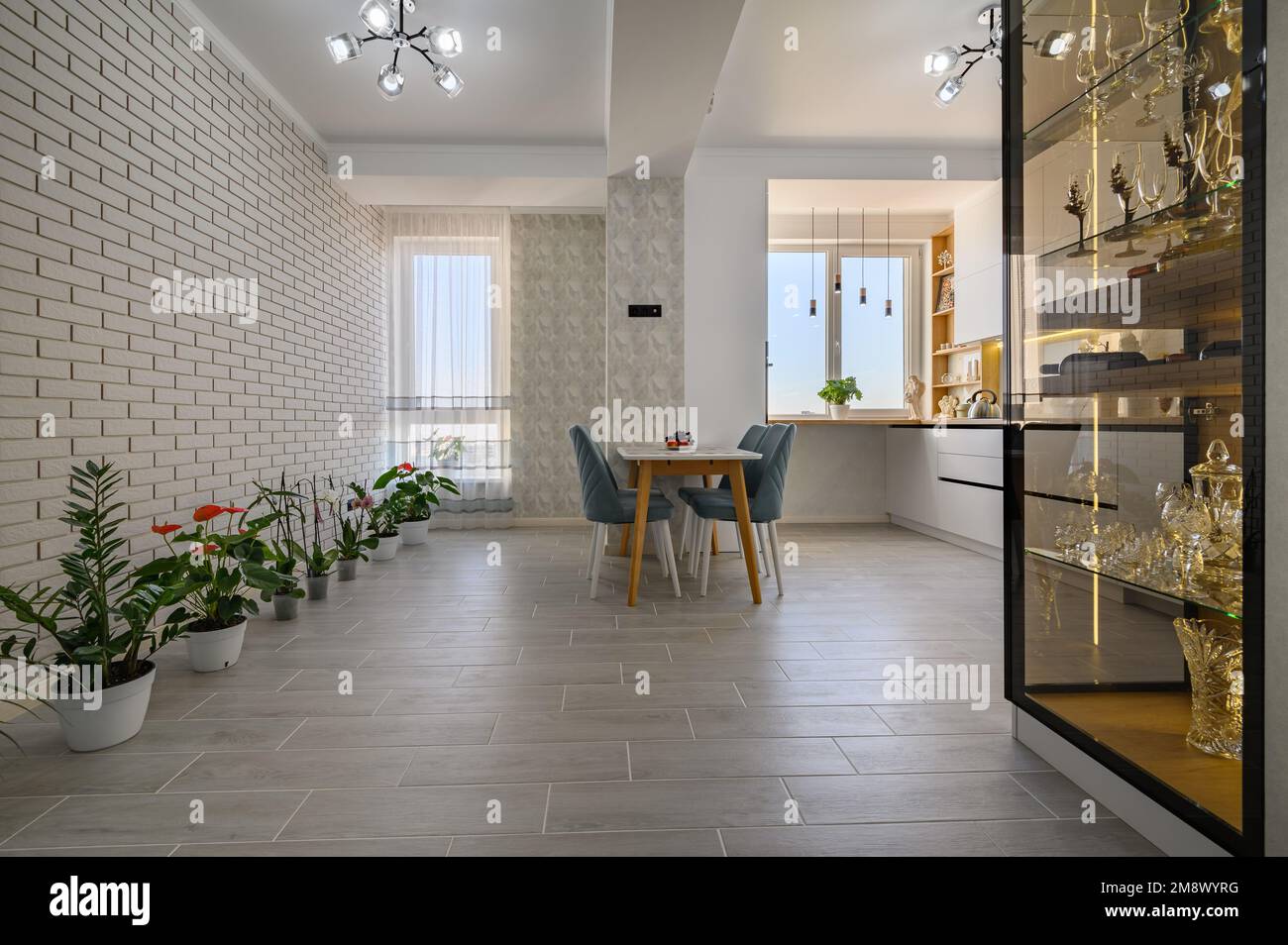 A modern white studio with a kitchen and dining area Stock Photo - Alamy