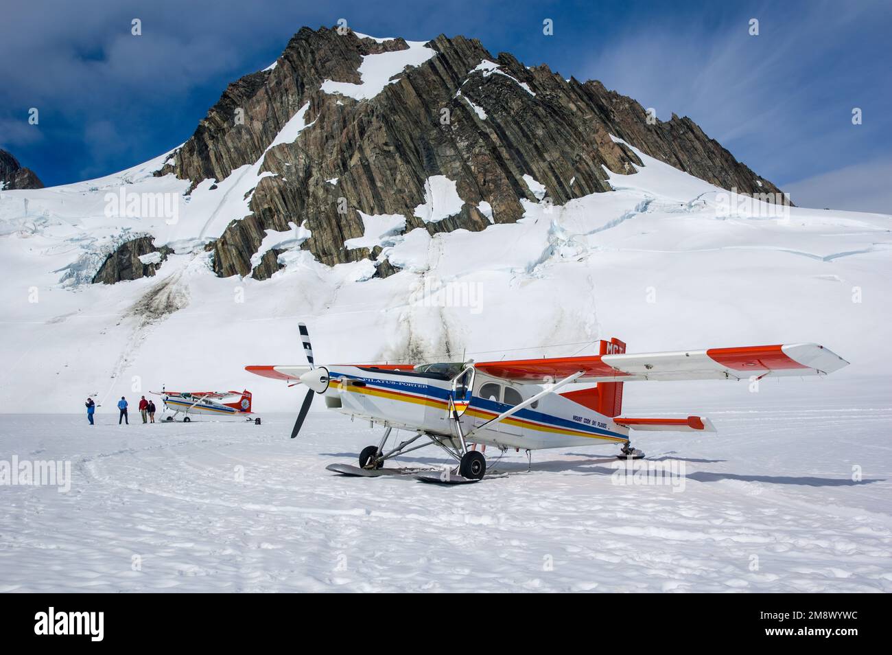Tourist flight landing by ski plane on the upper snow fields of Mount ...