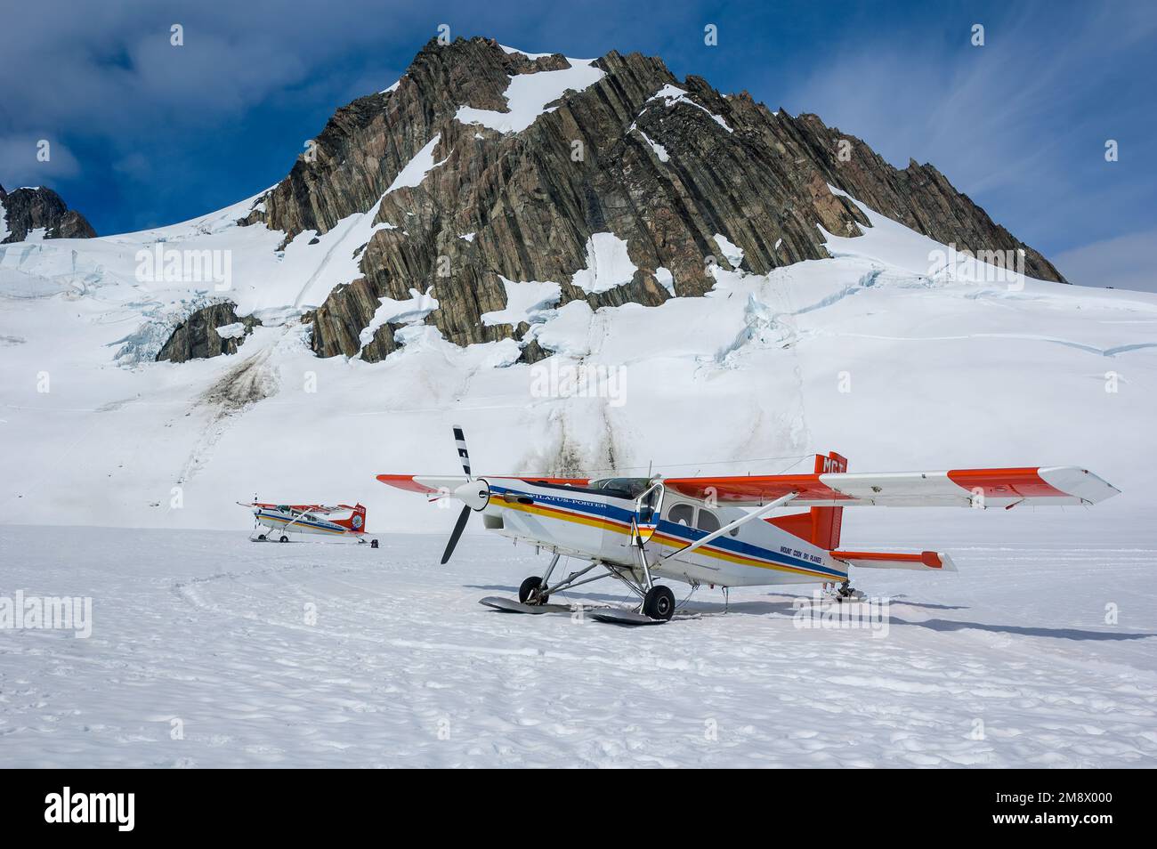 Tourist flight landing by ski plane on the upper snow fields of Mount ...