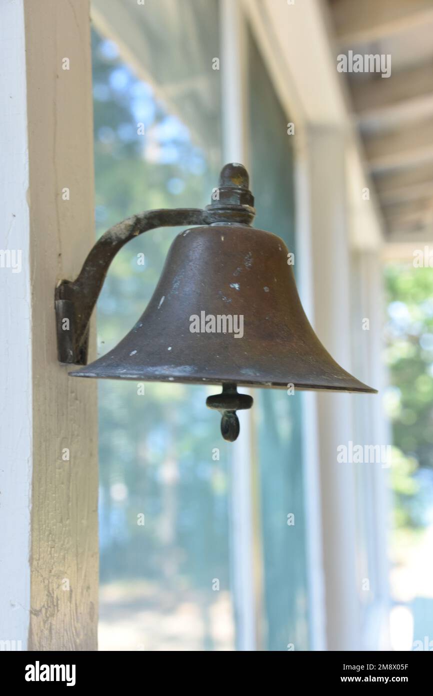 Old metal dinner bell on a screened porch waiting to be rung Stock ...