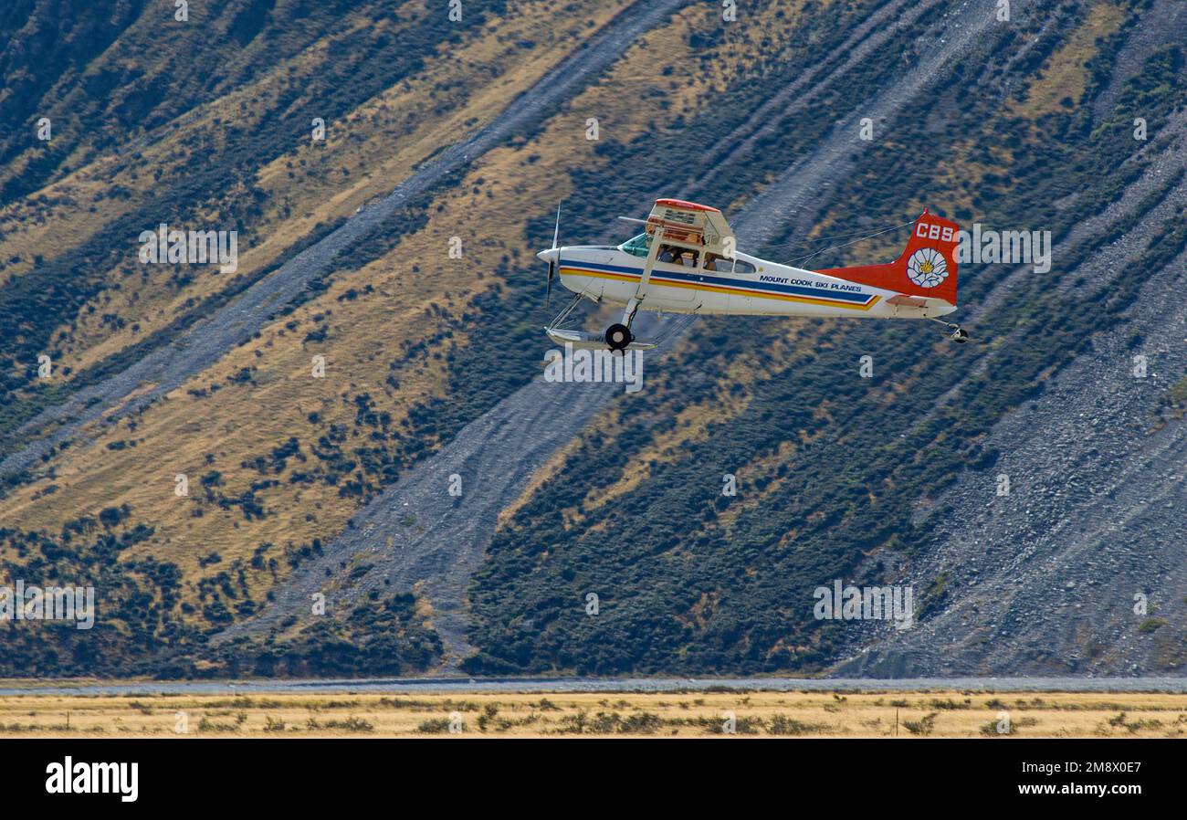 A ski plane taking off at Mount Cook Airport with tourists on a scenic ...