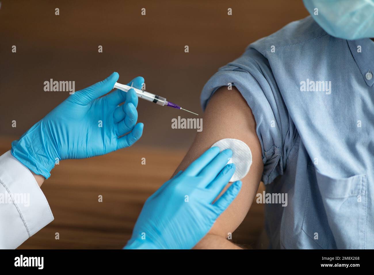 Unrecognizable Nurse Holding Syringe, Making Vaccine Shot To Male ...