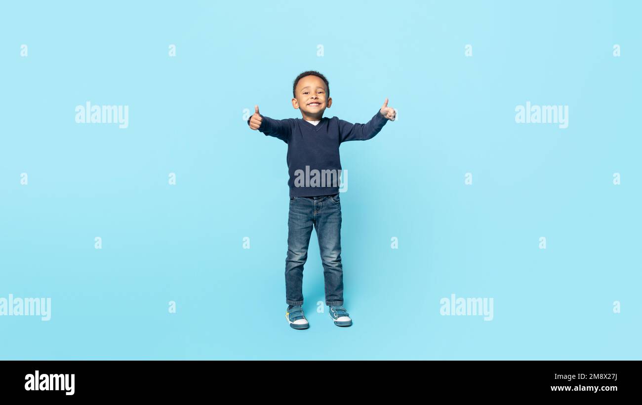 Sincere approval. Full length shot portrait of carefree little african ...