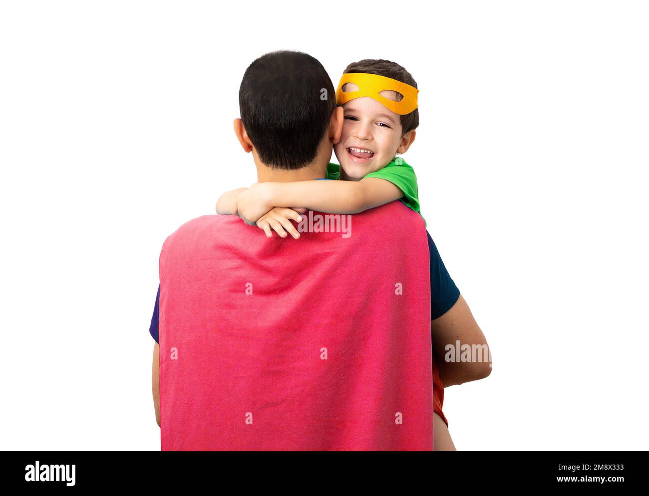 Affectionate little boy hugs his father with love, wears an orange mask ...