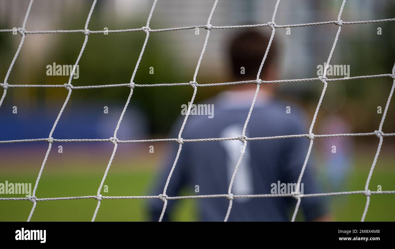 Goalkeeper through the net Stock Photo - Alamy