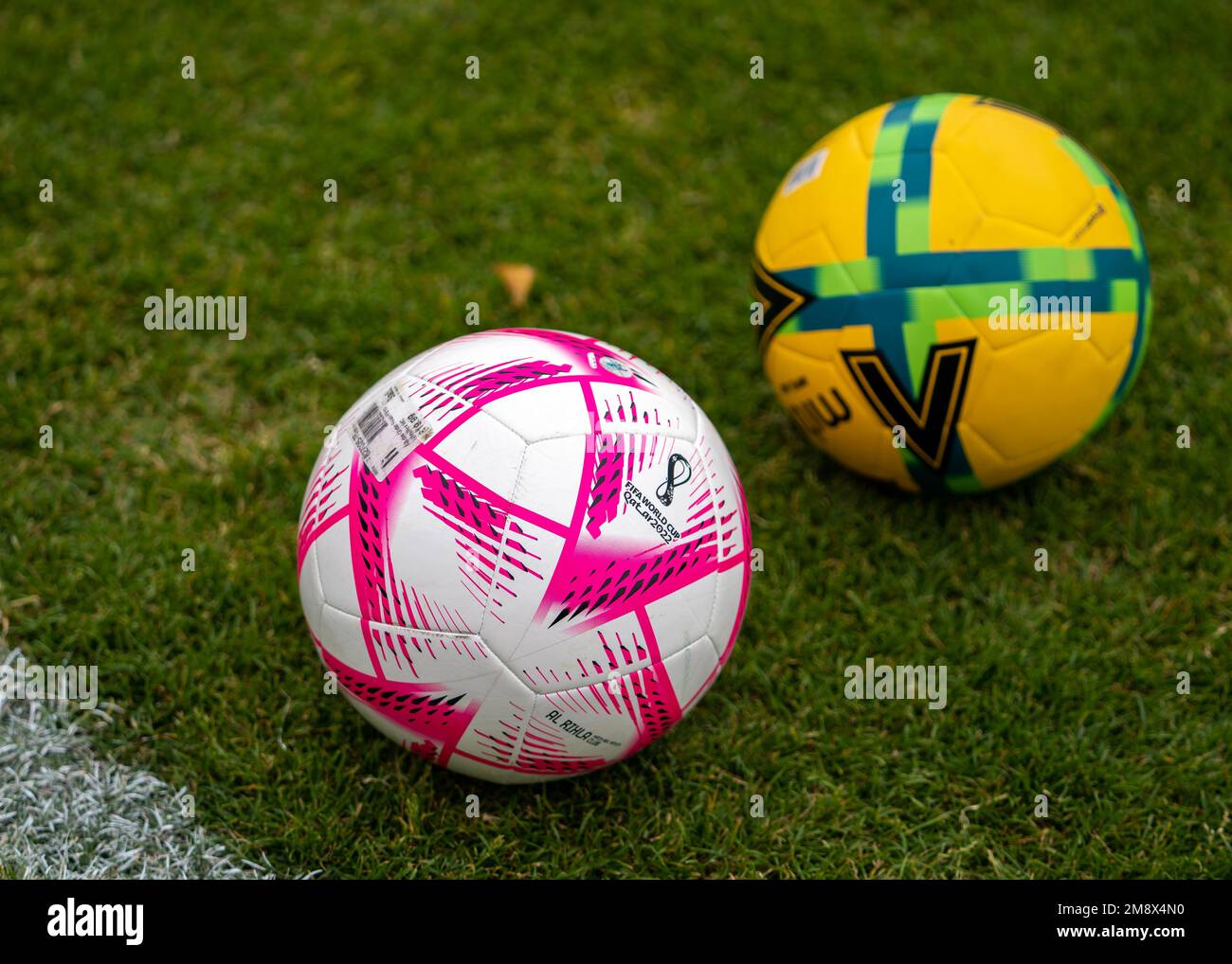 two footballs on pitch Stock Photo - Alamy