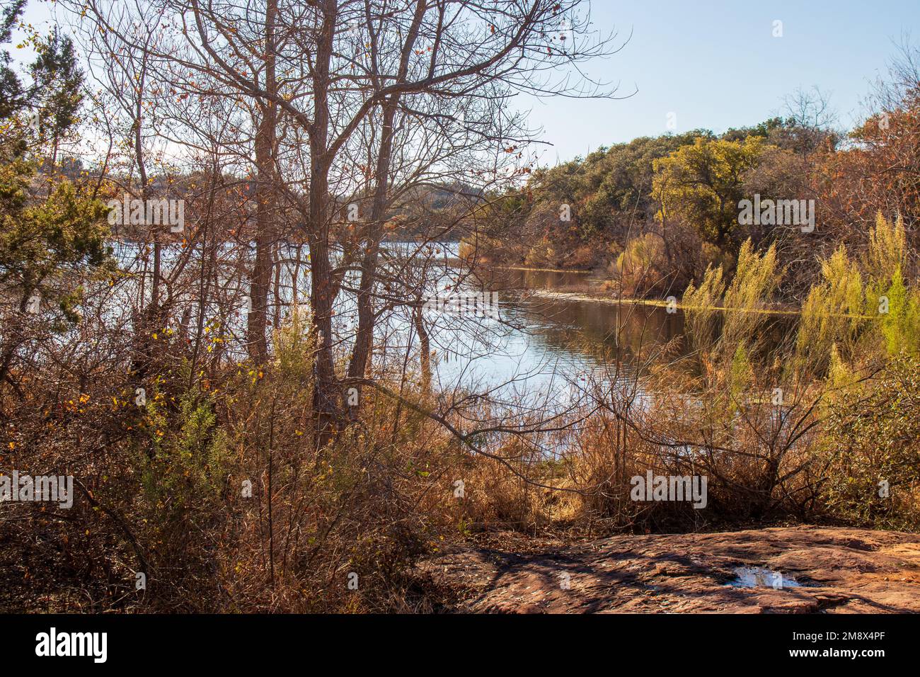 Texas Hill Country hiking trail with a view of Inks Lake. The autumn ...