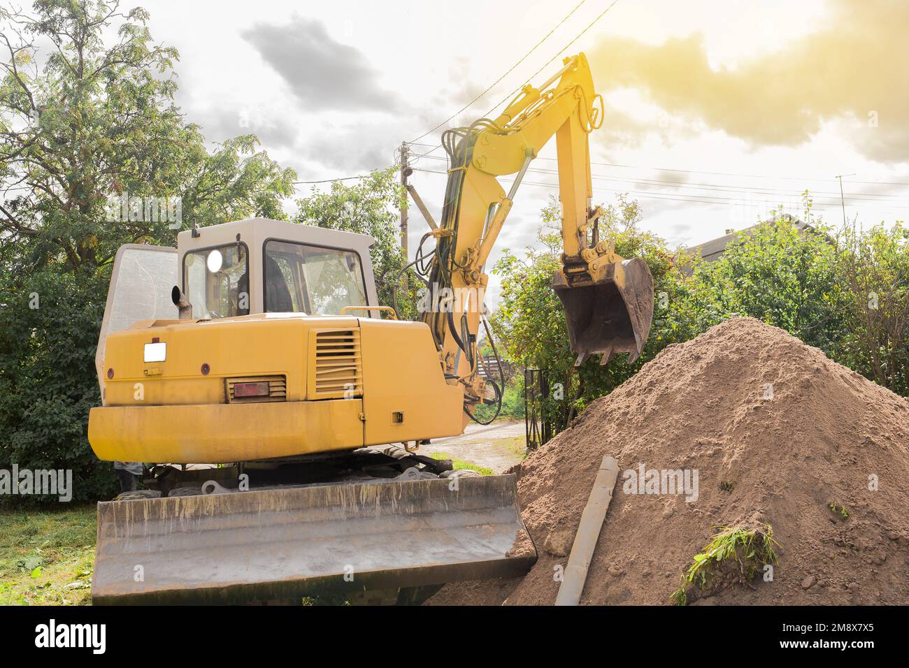 A bulldozer is digging on outdoors in an industrial site. Excavation ...
