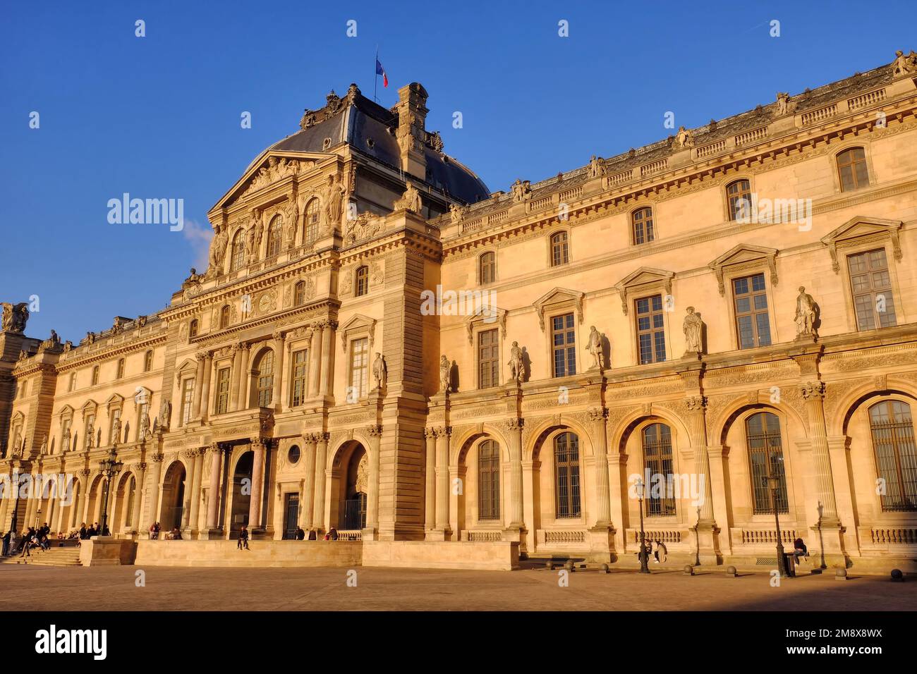 Paris: Louvre Museum Pavillon Sully glowing orange soon before sunset ...