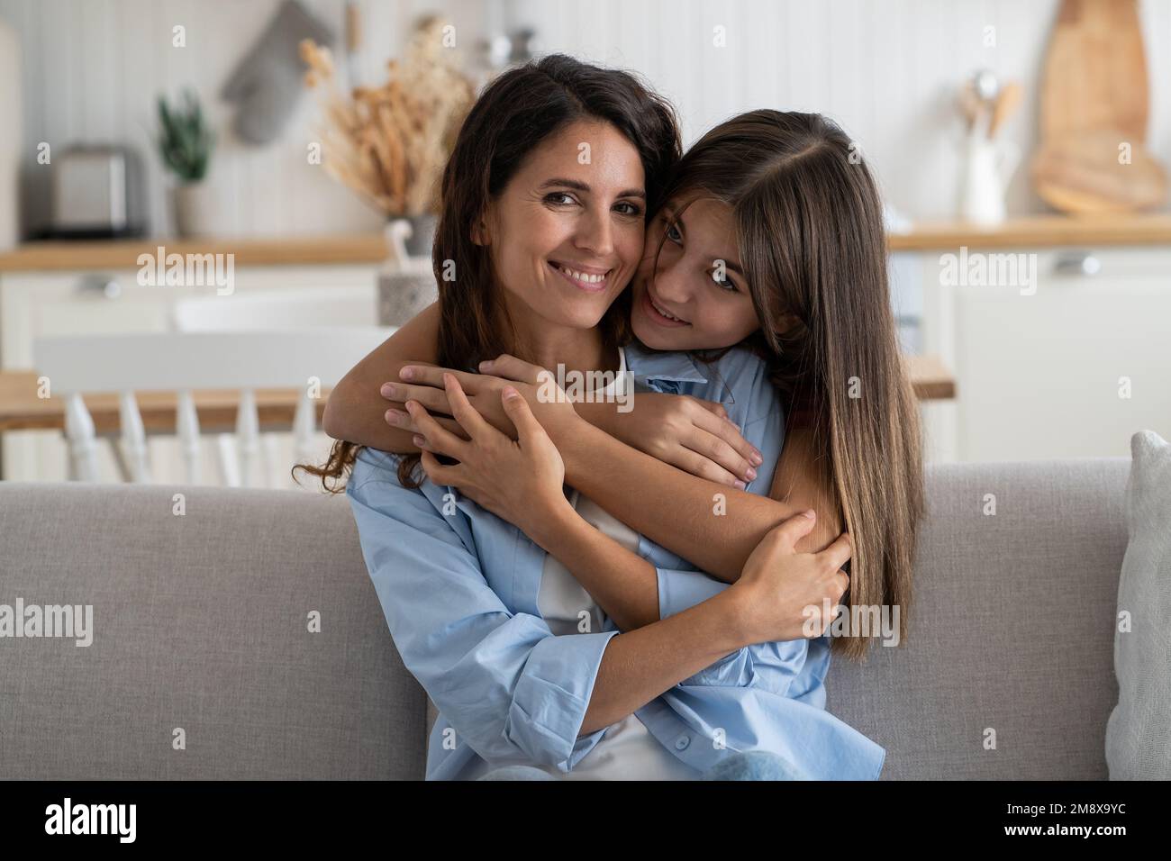 Mother-daughter connection. Cute girl child cuddling smiling mom ...
