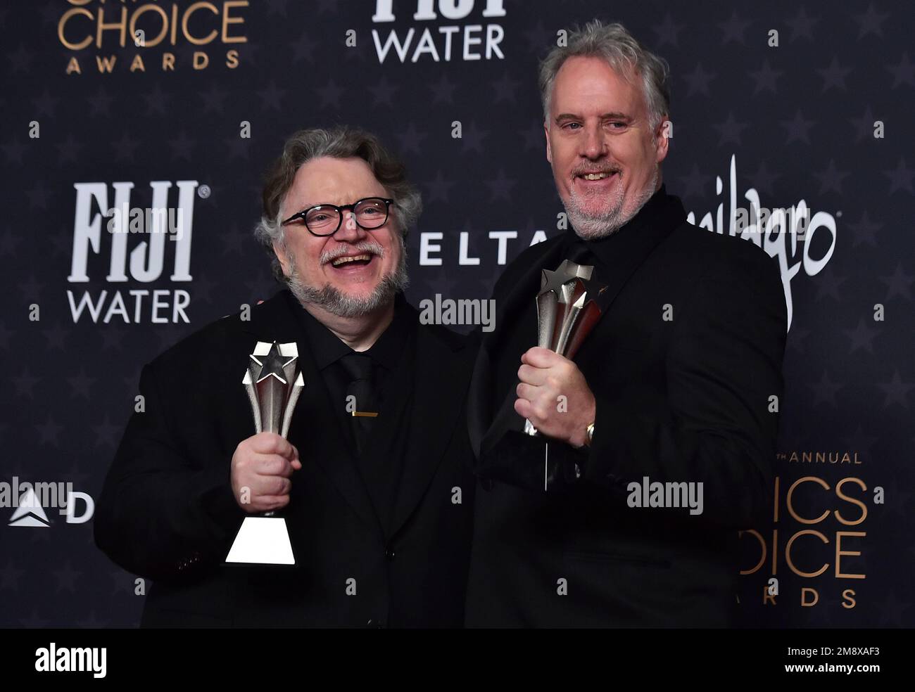 Guillermo del Toro, left, and Mark Gustafson pose in the press room ...