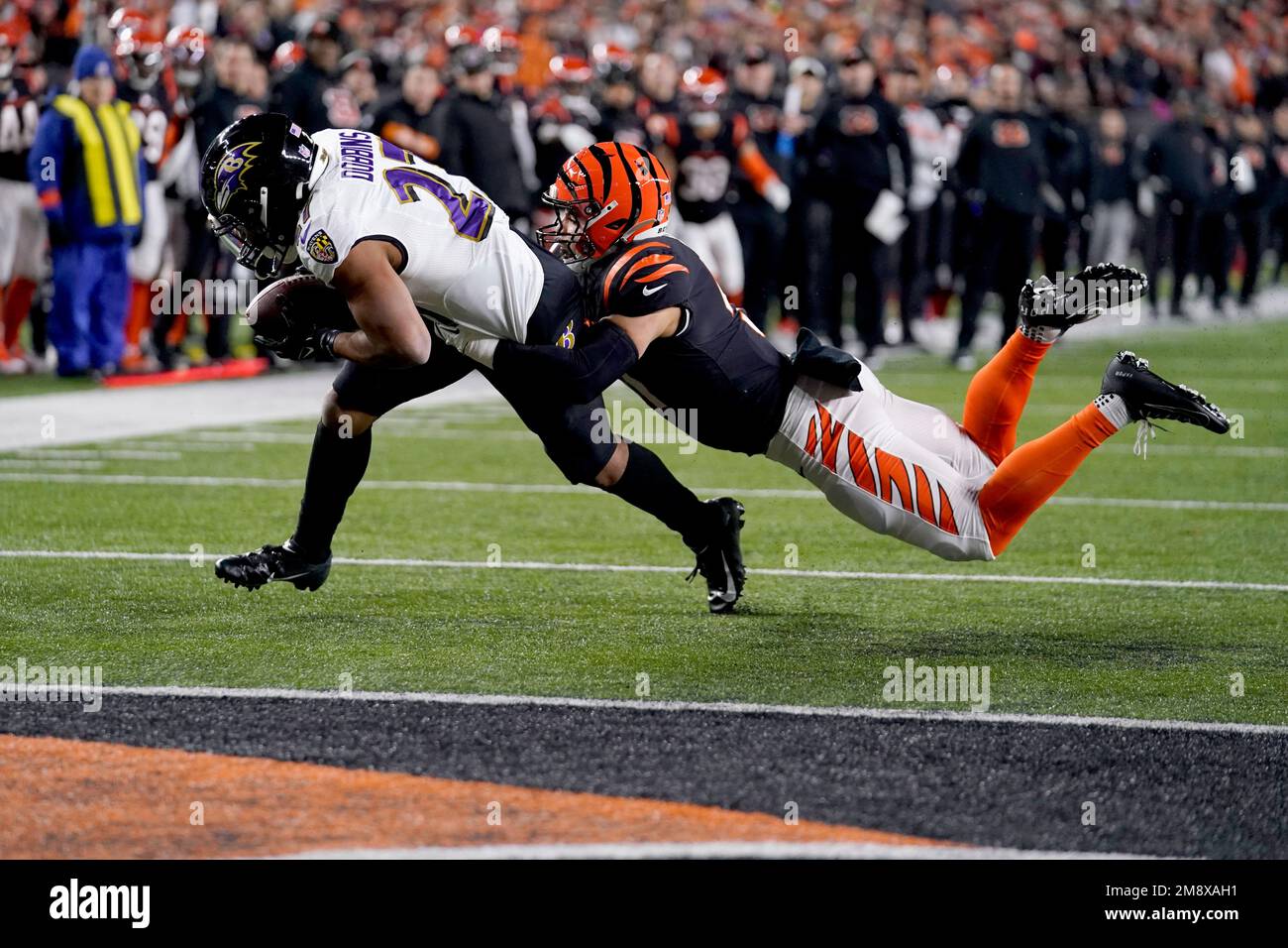 Baltimore Ravens running back J.K. Dobbins, left, scores as Cincinnati ...