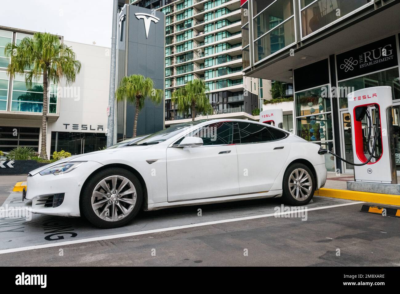 A Tesla electric vehicle recharging at a Supercharger station in ...