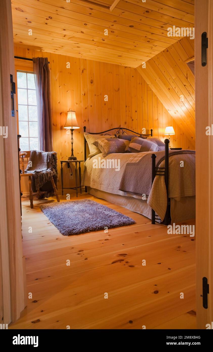 Queen size bed with cast iron tubular headboard and footboard in guest ...